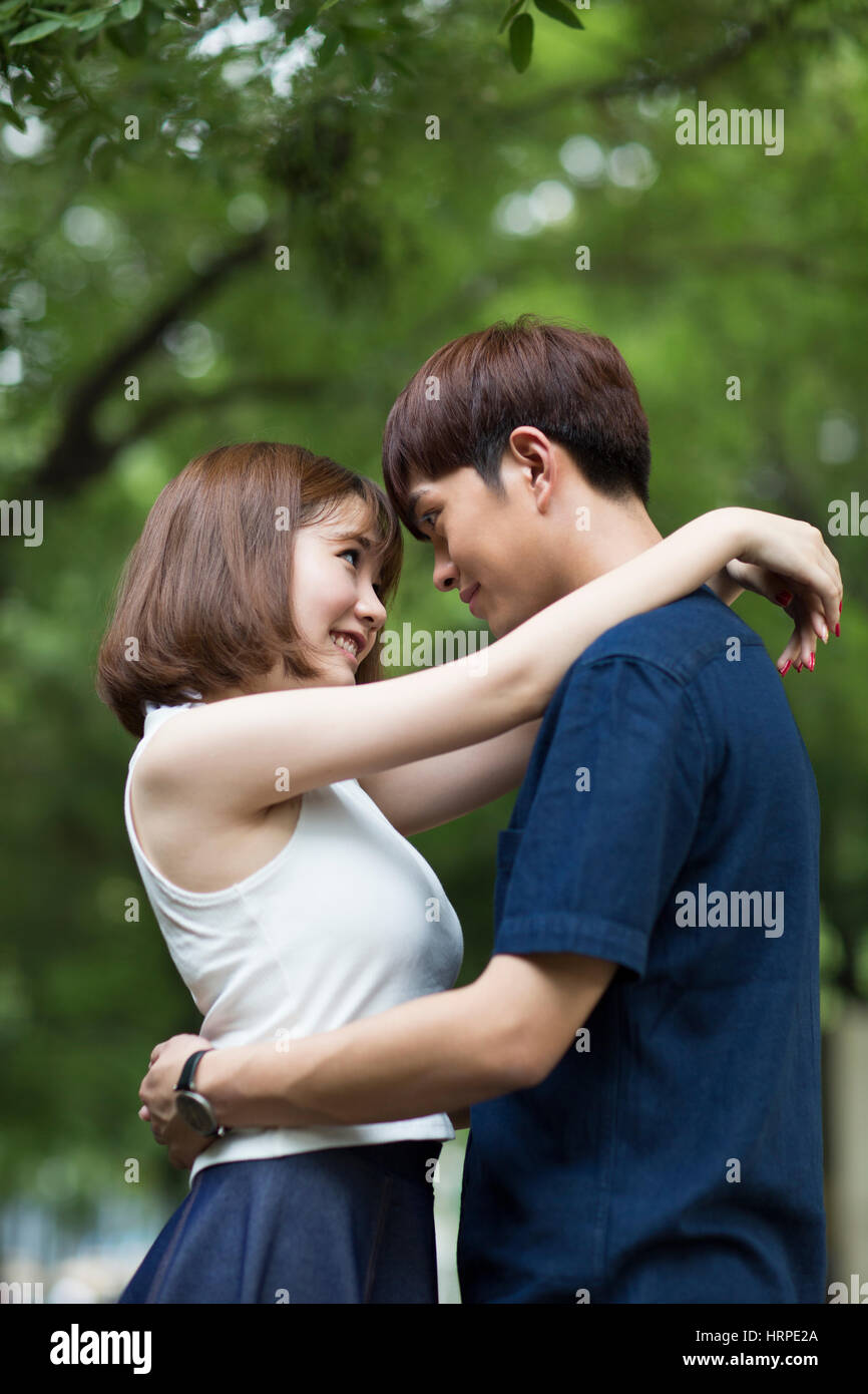 Happy young couple embracing Stock Photo - Alamy