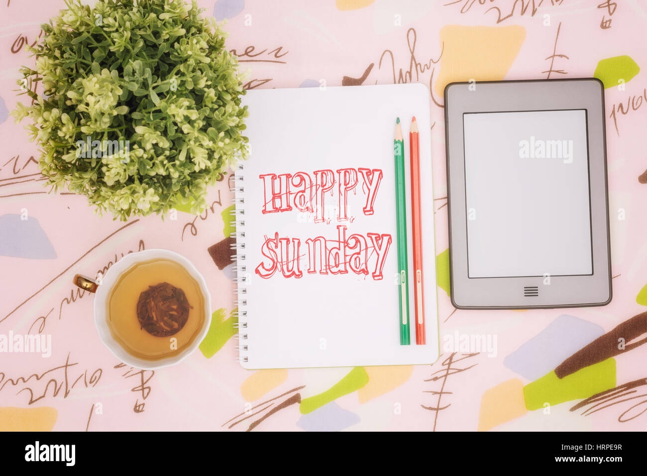 Tea cup, ebook and notebook with an inscription: happy sunday Stock ...