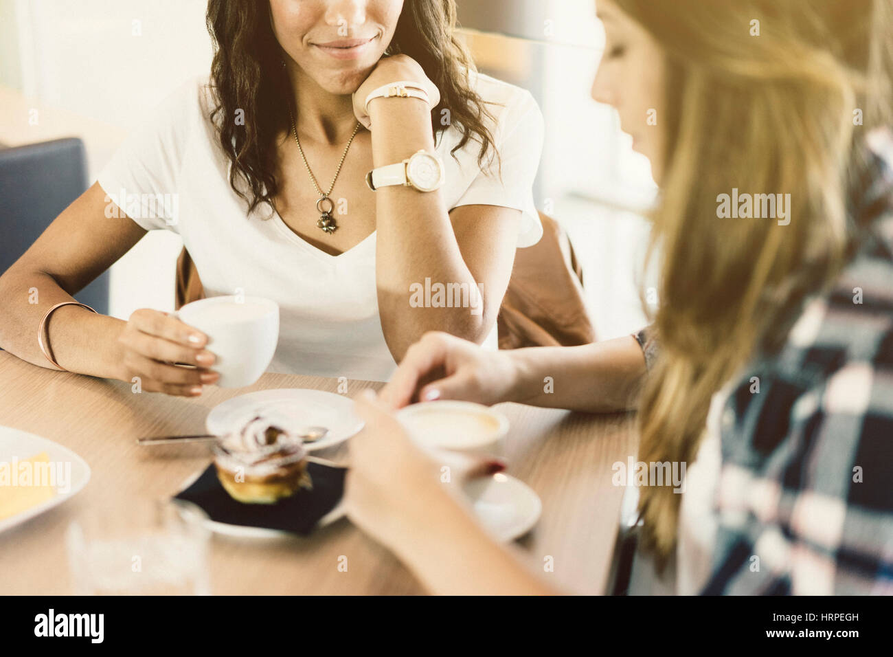 Two women sitting at a table in a bar hi-res stock photography and ...
