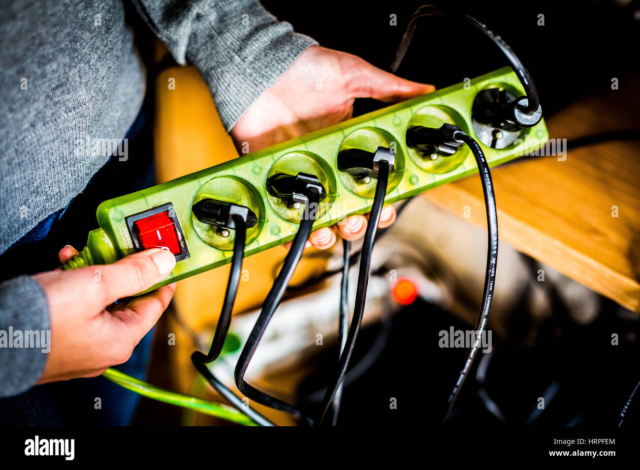 Woman using a power strip Stock Photo - Alamy