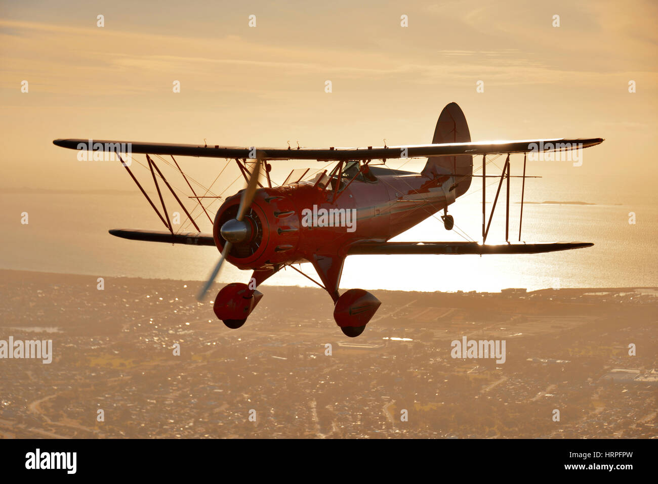 WACO YMF-F5C biplane with setting sun in background Stock Photo - Alamy