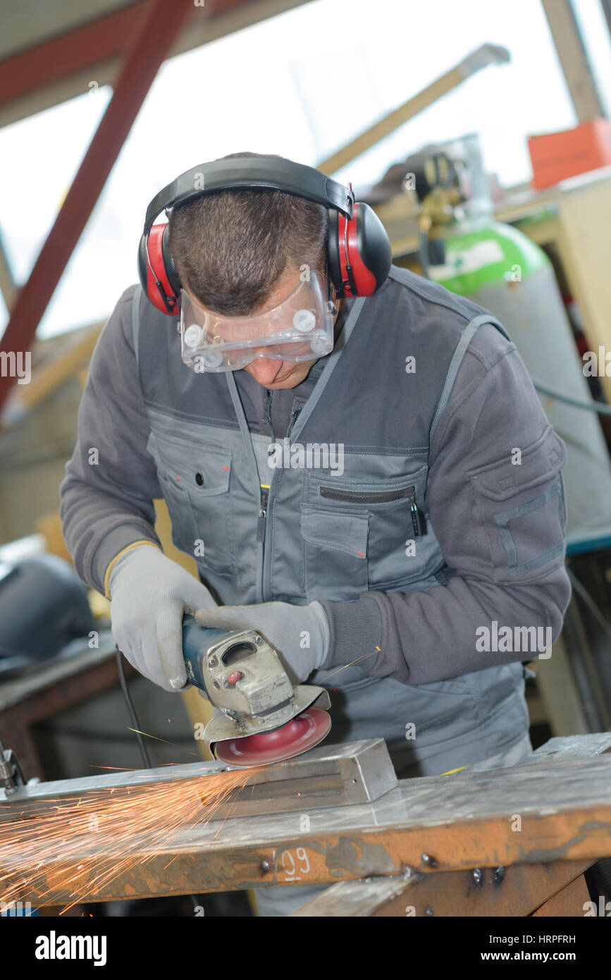 Worker grinding metal Stock Photo - Alamy