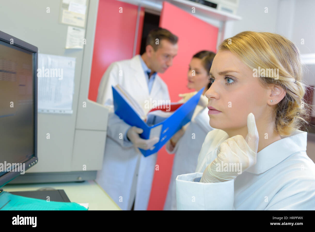 Woman looking with confusion at computer screen Stock Photo - Alamy