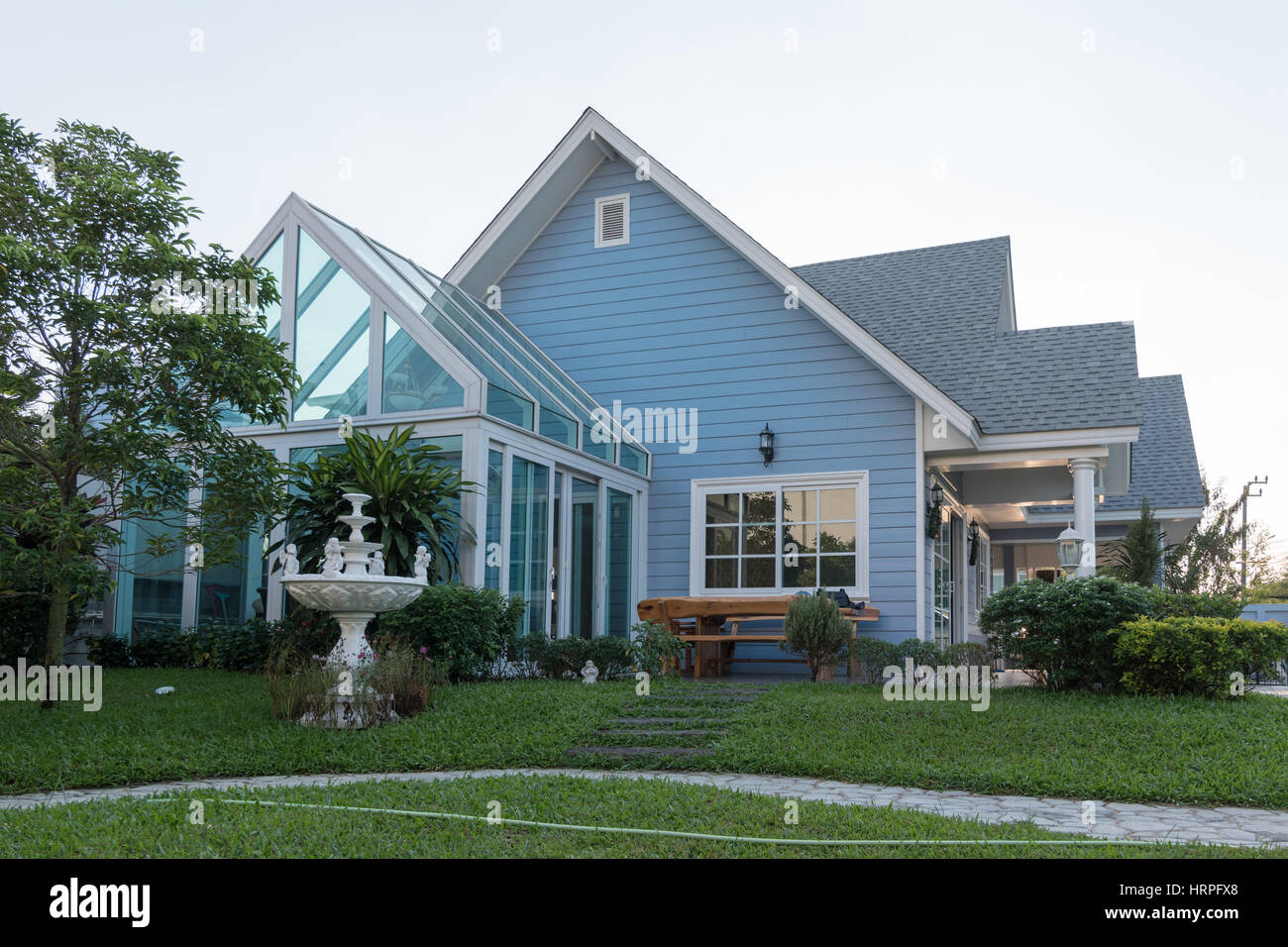 Bright blue house in sunlght with colorful poppies and some graceful ...