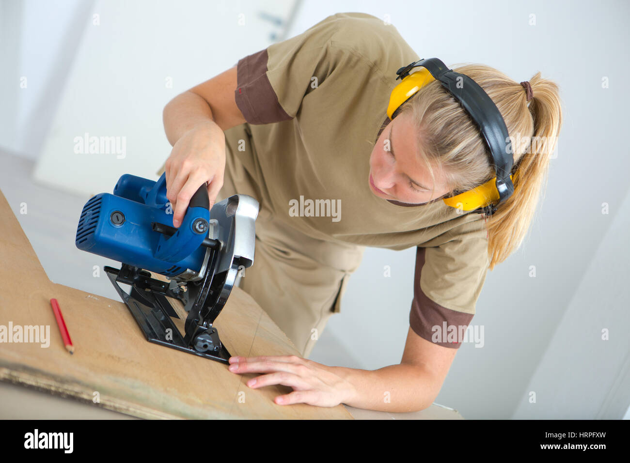 Female worker using jigsaw Stock Photo - Alamy