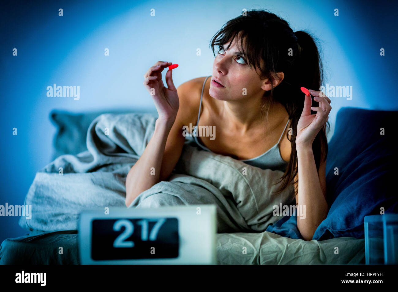 Woman wearing ear plugs hi-res stock photography and images - Alamy