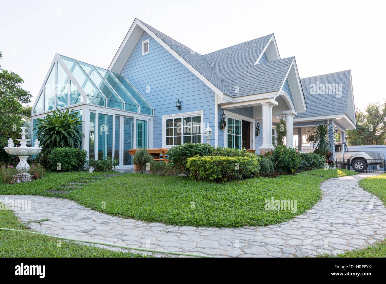 Bright blue house in sunlght with colorful poppies and some graceful ...