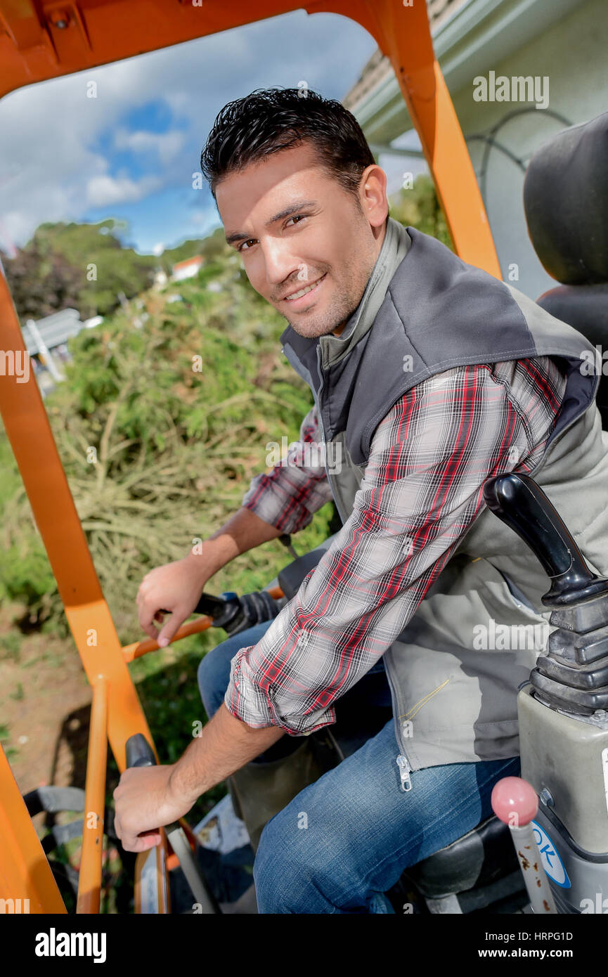 Man operating a digger Stock Photo - Alamy