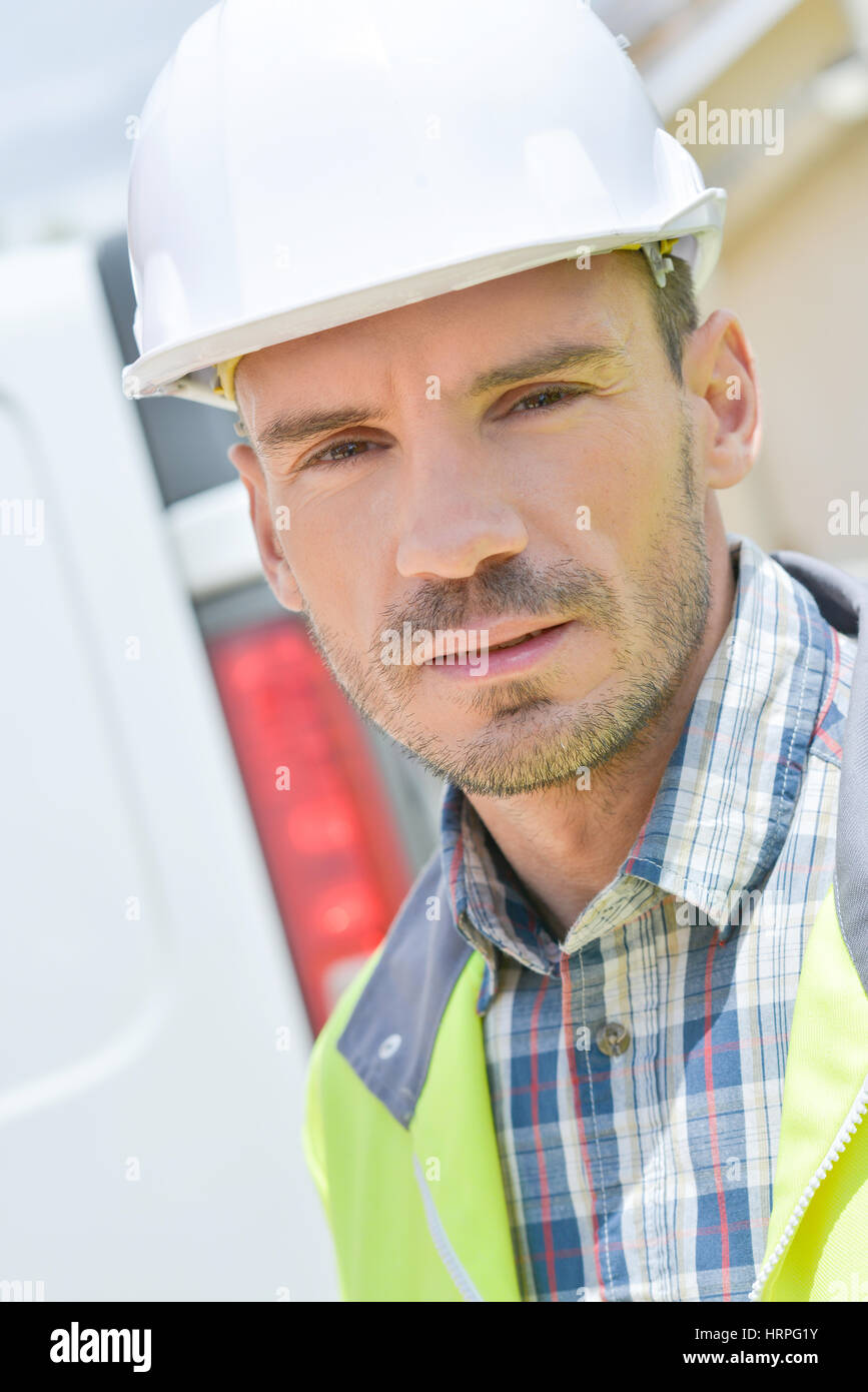 Builder wearing high visibility vest Stock Photo - Alamy