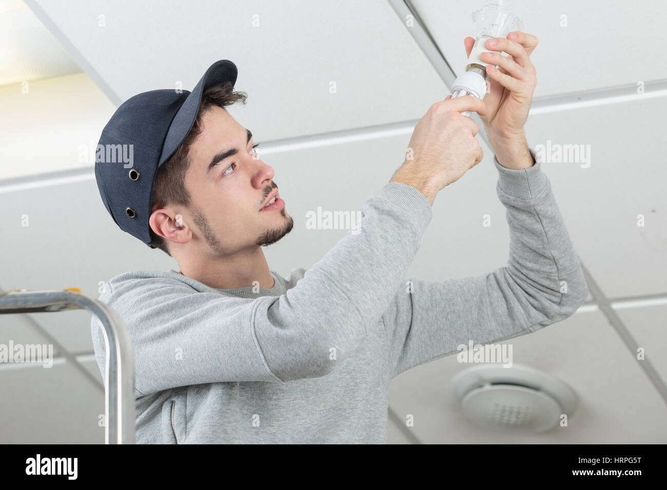handsome young electrician working at construction site Stock Photo - Alamy