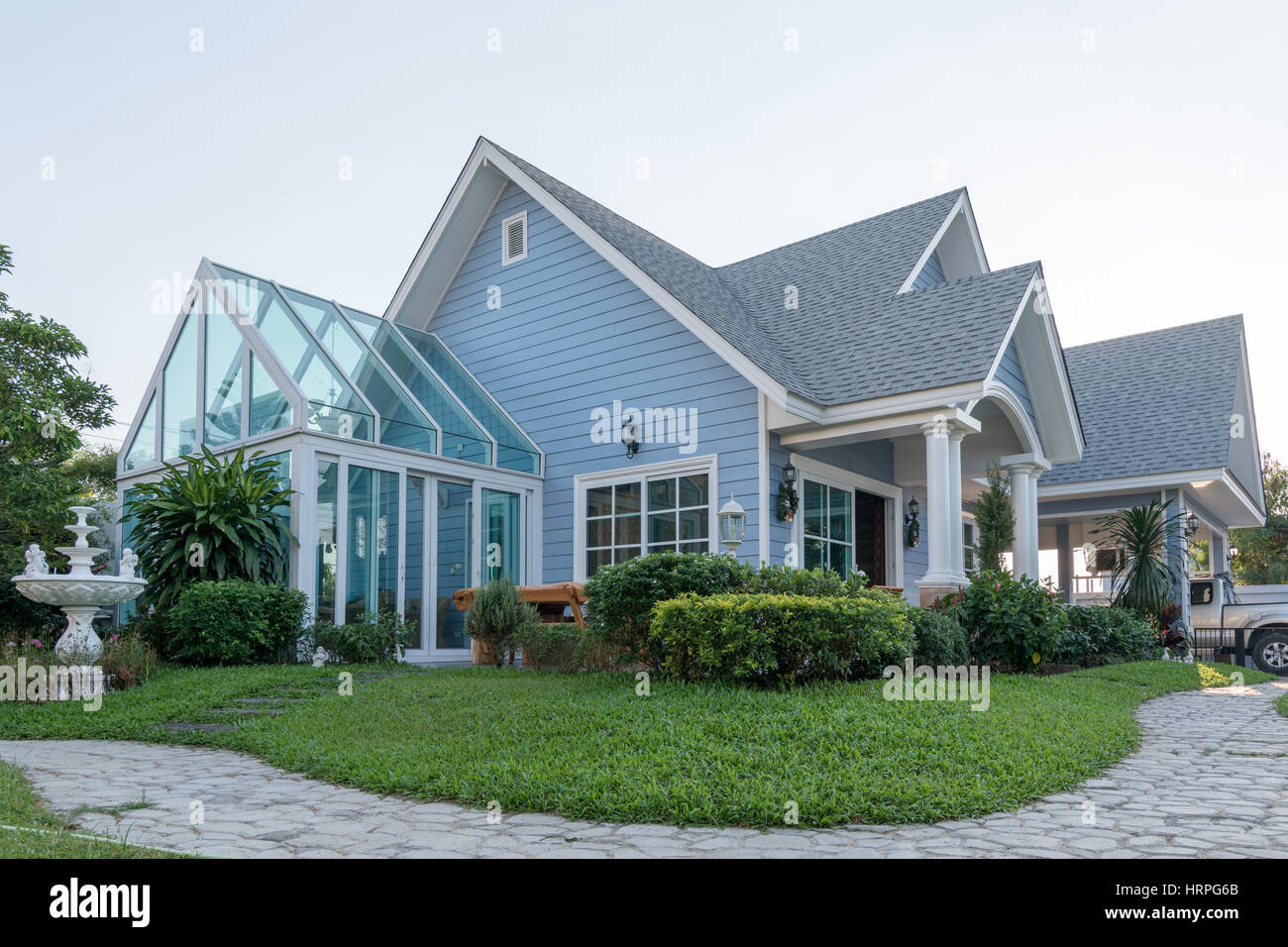 Bright blue house in sunlght with colorful poppies and some graceful ...