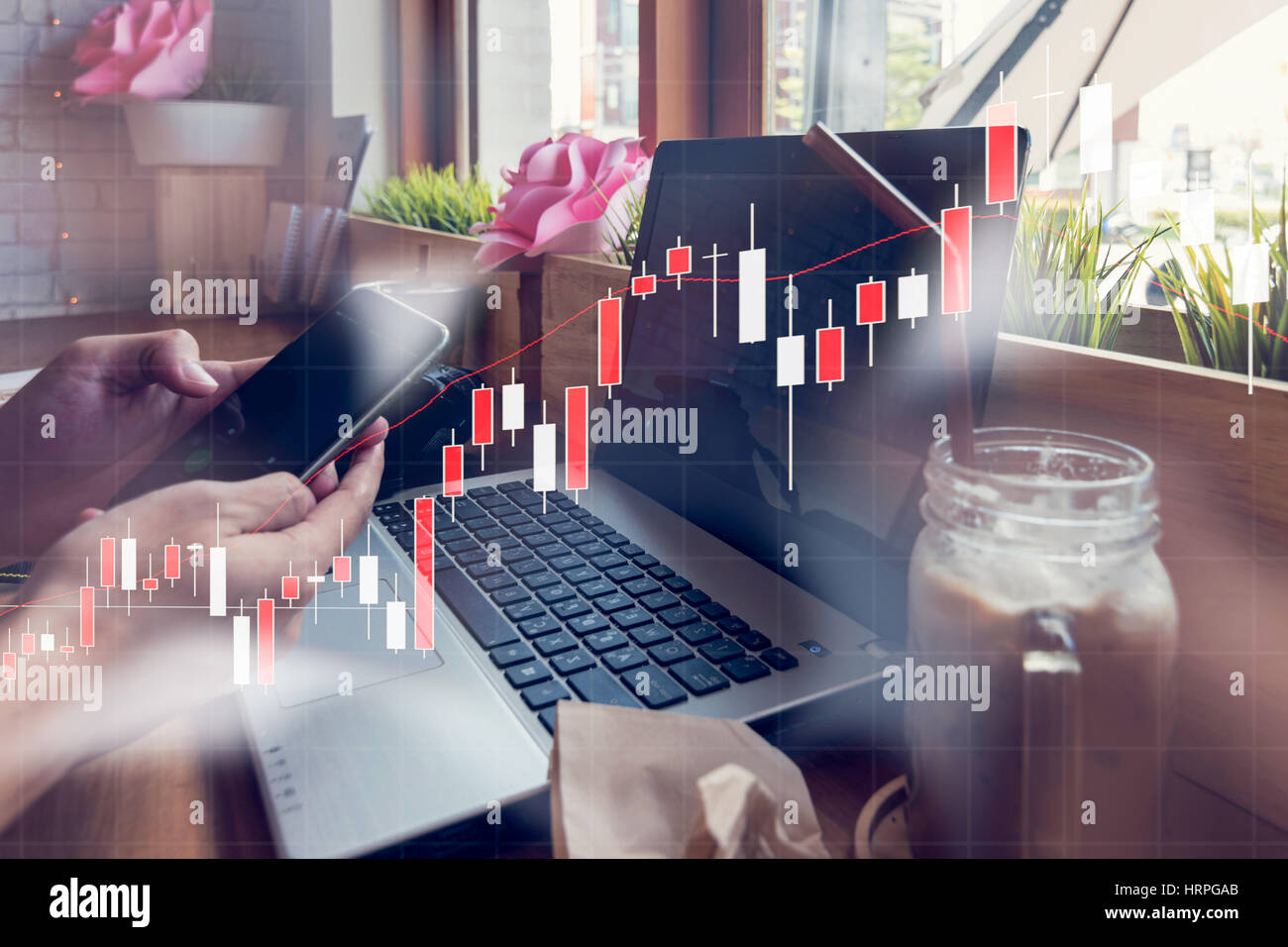 Businessman is working with his computer in coffee shop with stock ...