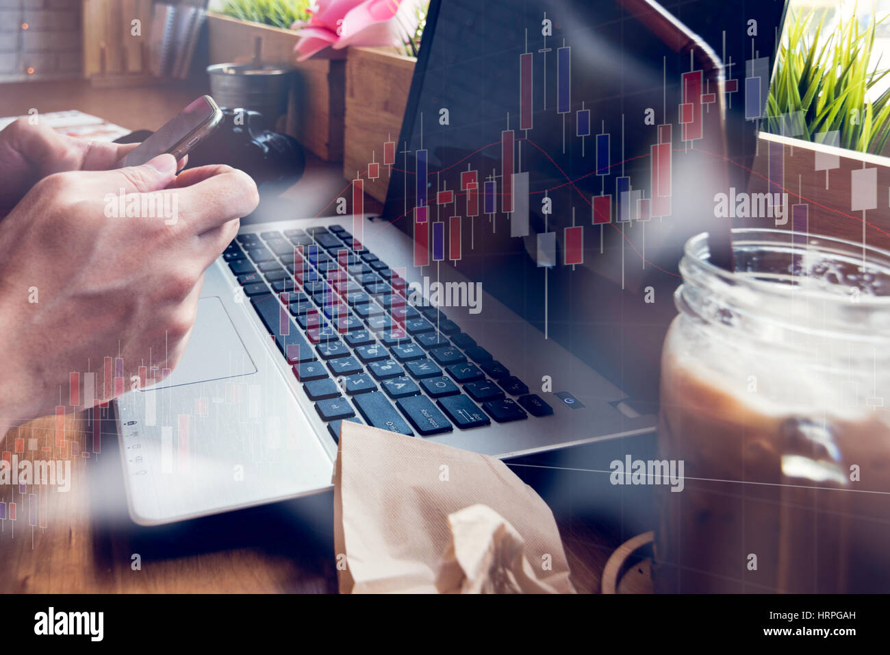 Businessman is working with his computer in coffee shop with stock ...