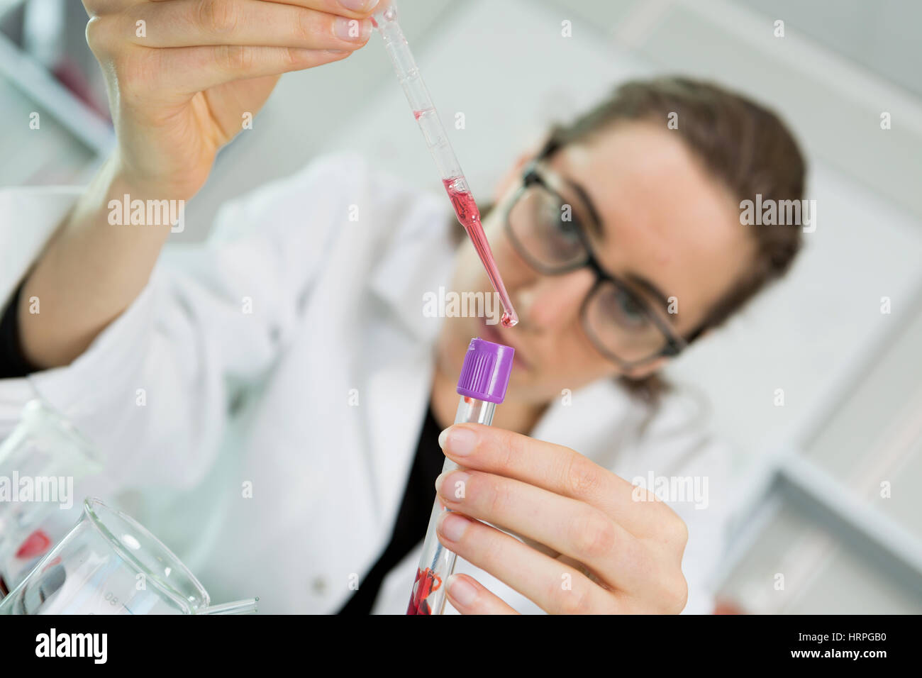 concentrated scientist pouring fluid Stock Photo - Alamy