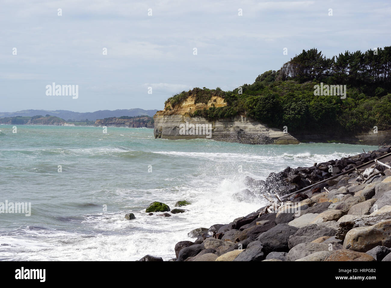 Cliff face bordering the ocean at Urenui, the beach community close to ...