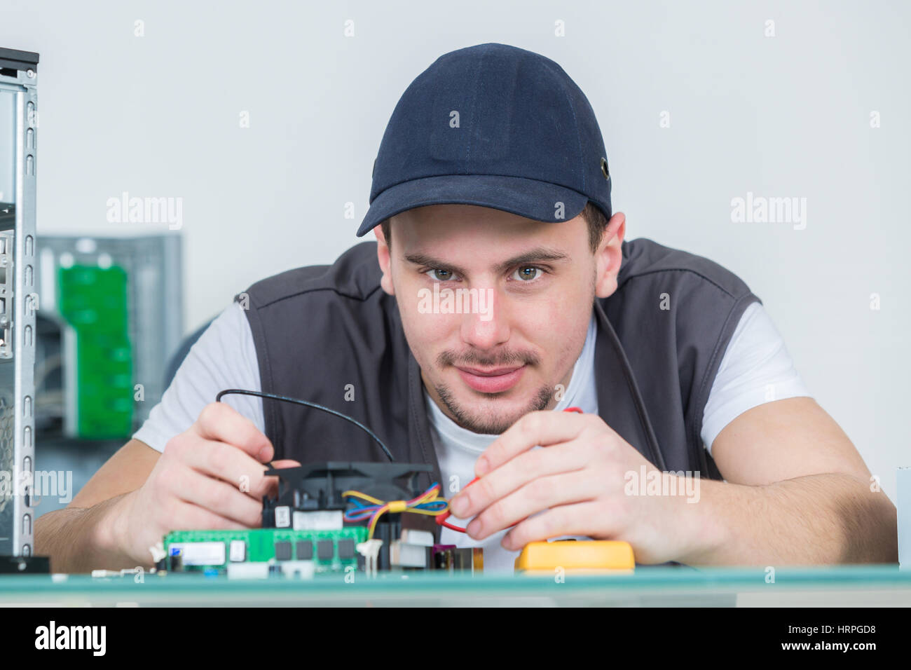 electronic engineer repairing electronic devices on broken computer ...
