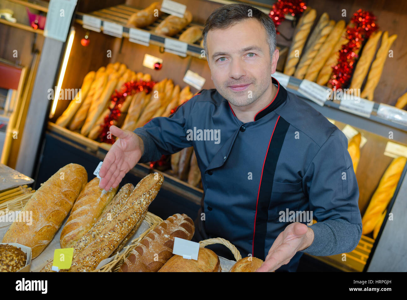 bakery shopkeeper is proud of his bread production Stock Photo - Alamy