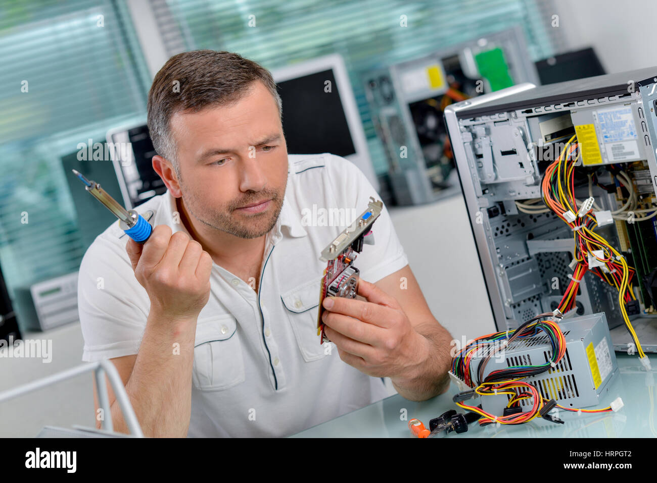 Electronics repairman fixing broken hi-res stock photography and images ...