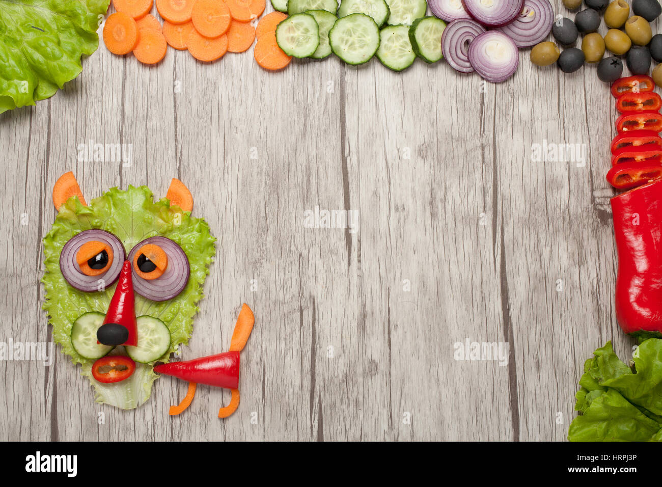 Funny wolf and vegetables on wooden desk Stock Photo - Alamy