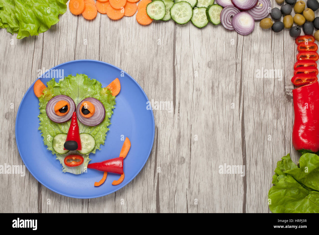 Vegetable wolf on plate and ingredients on table Stock Photo - Alamy