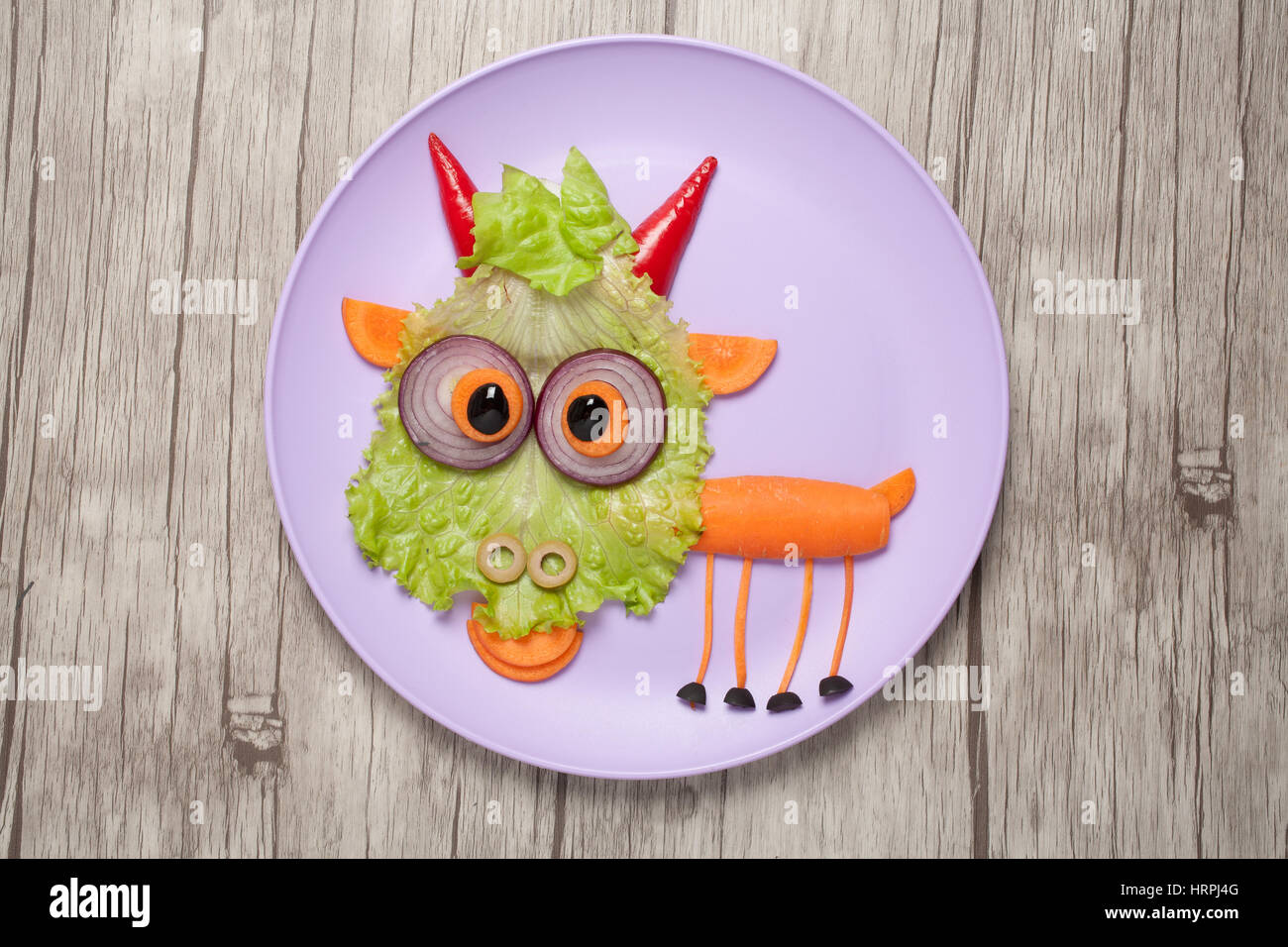 Funny vegetable goat made on plate and desk Stock Photo - Alamy