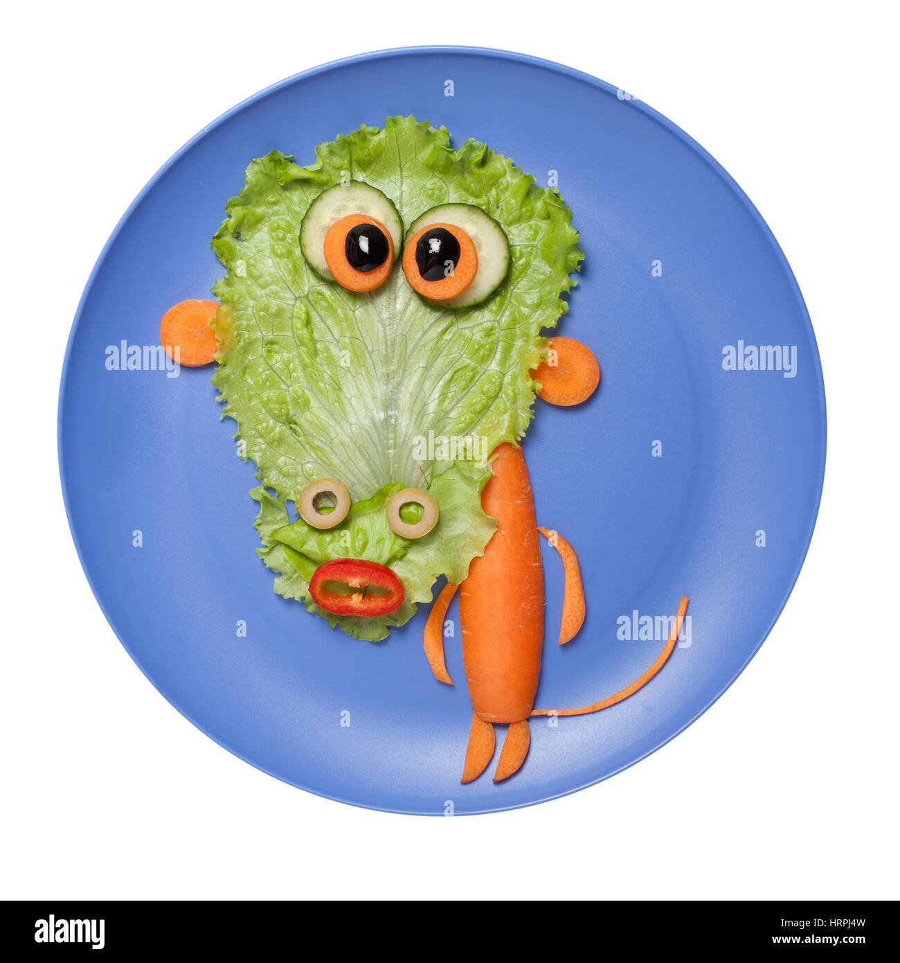 Surprised vegetable ape made on blue plate Stock Photo - Alamy