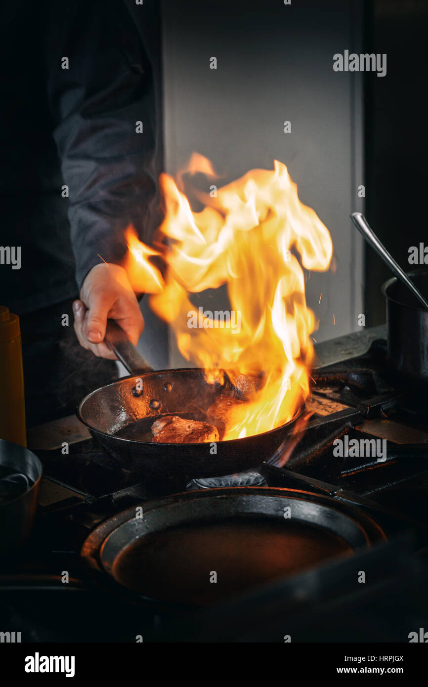 Professional chef cooking flambe style hi-res stock photography and ...