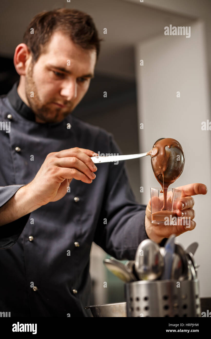 Chef pouring creamy chocolate dessert in glass Stock Photo - Alamy