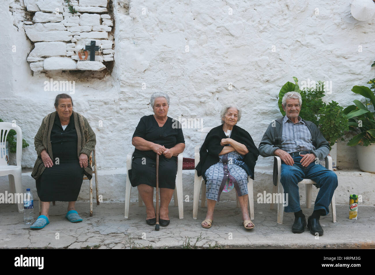 Elderly people sitting by the side of the alley inside the castle of ...