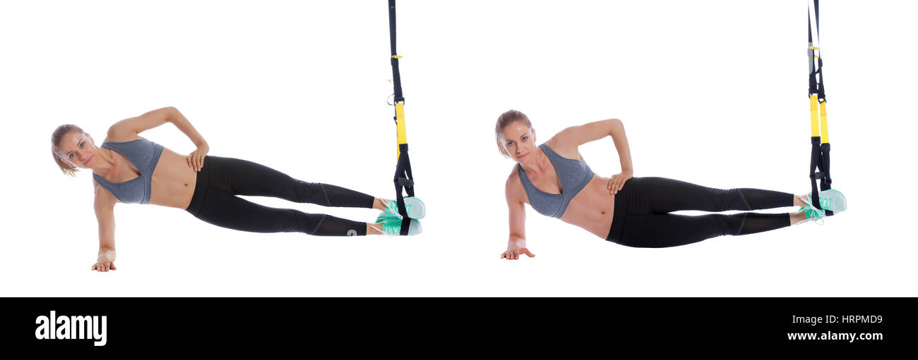 Athletic woman performing a functional exercise with suspension cable ...