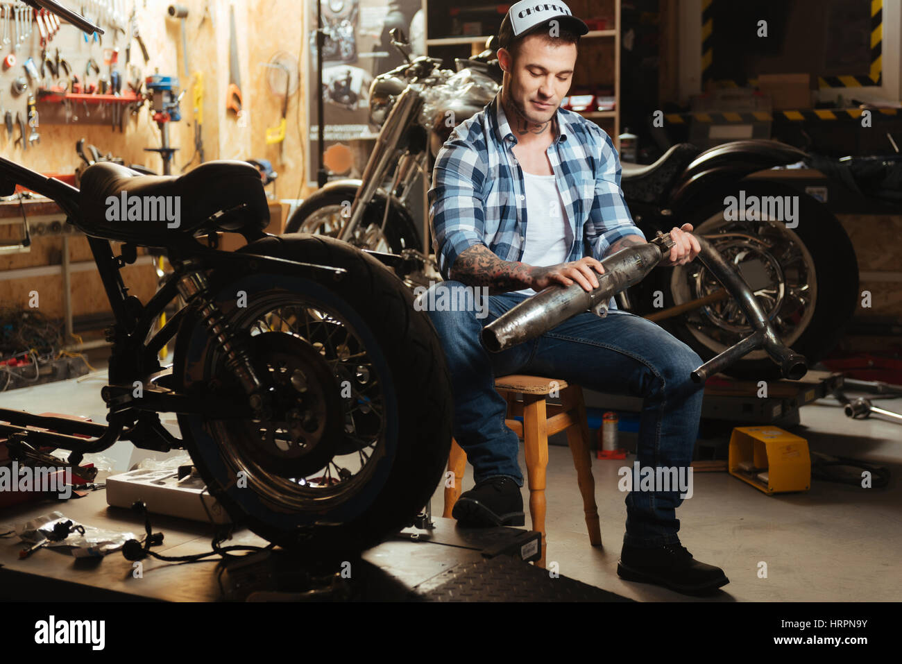 Right decision. Delighted handsome master wearing jeans and blue ...