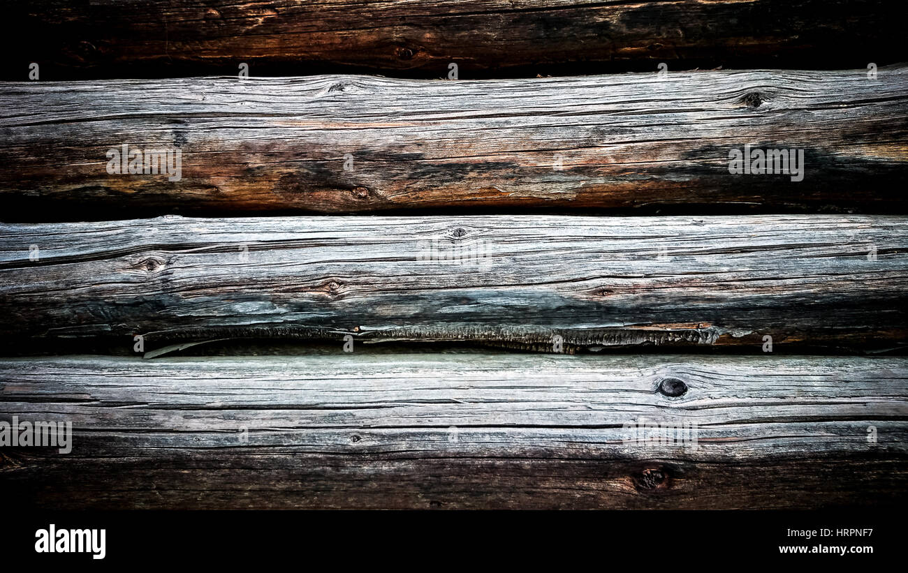 The wall of round, old logs as background Stock Photo - Alamy