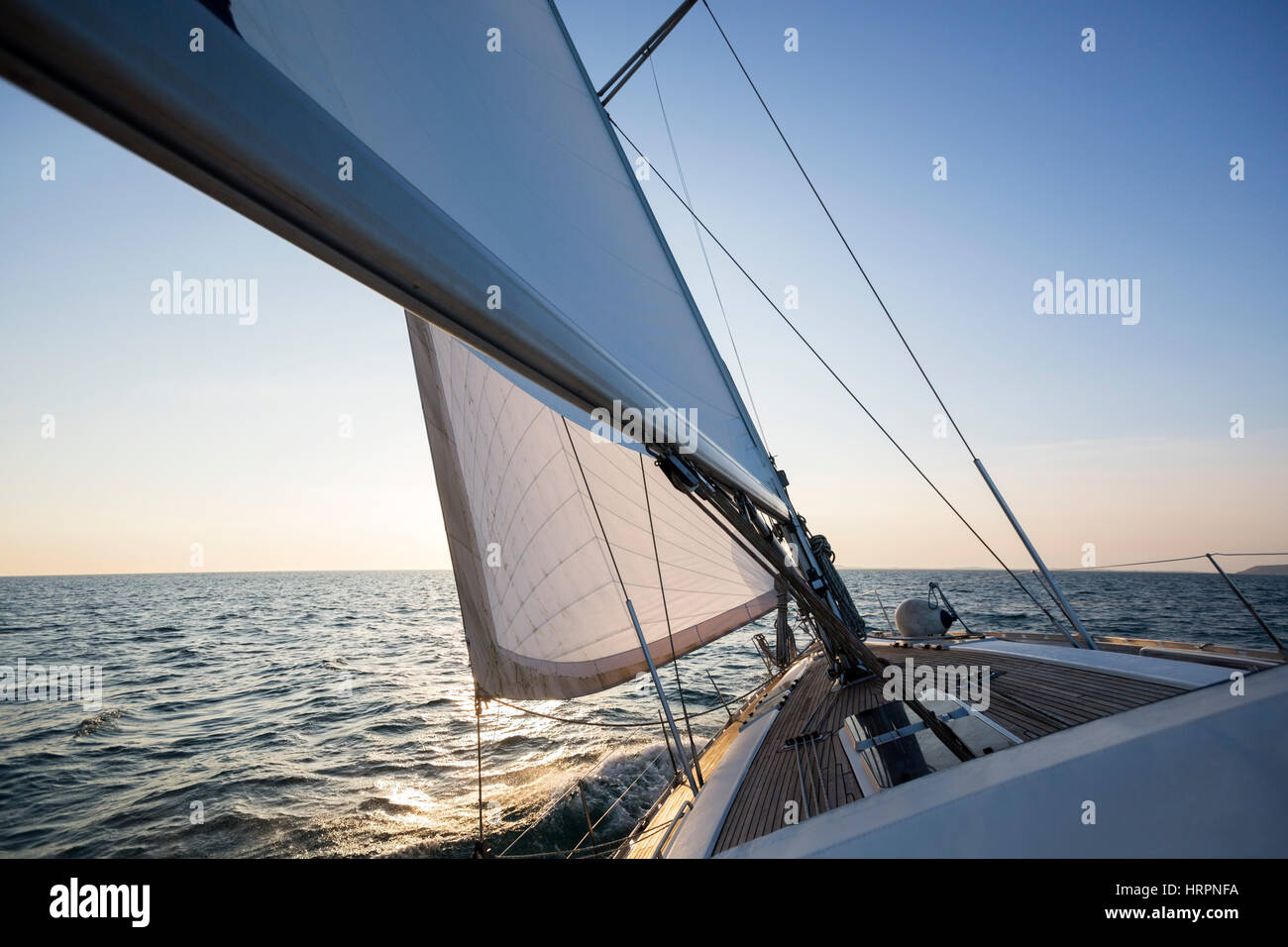 Luxury boat sailing in open sea during sunset Stock Photo - Alamy