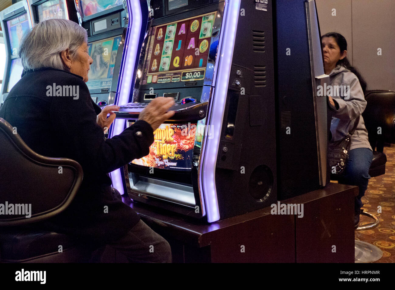 Elderly customers gambling at slot machines at a casino in Puerto Varas ...