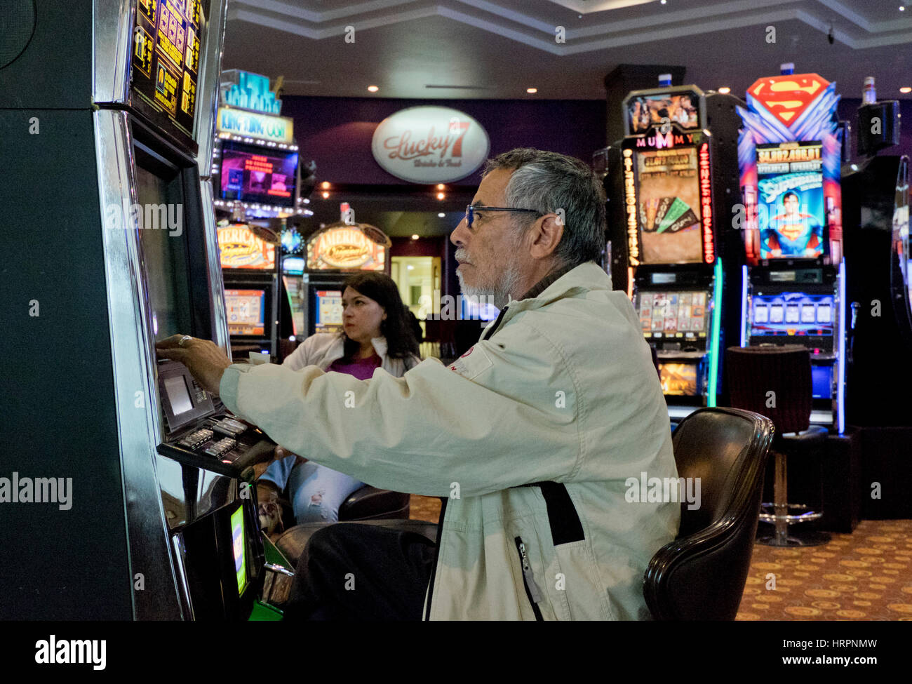 Elderly customers gambling at slot machines at a casino in Puerto Varas ...