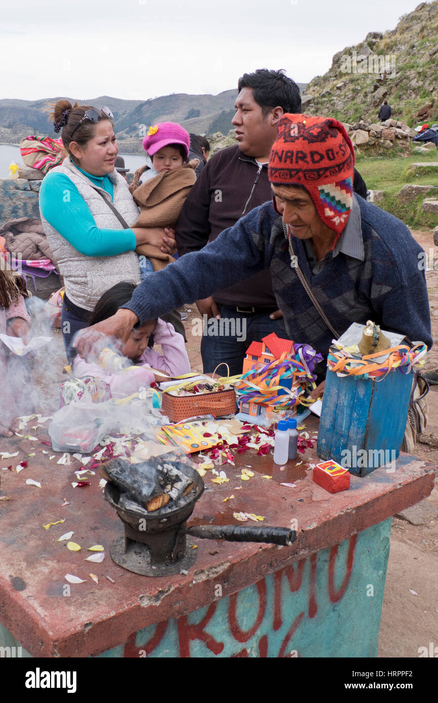 Native Aymara healer performing a ceremony for a local family in the ...