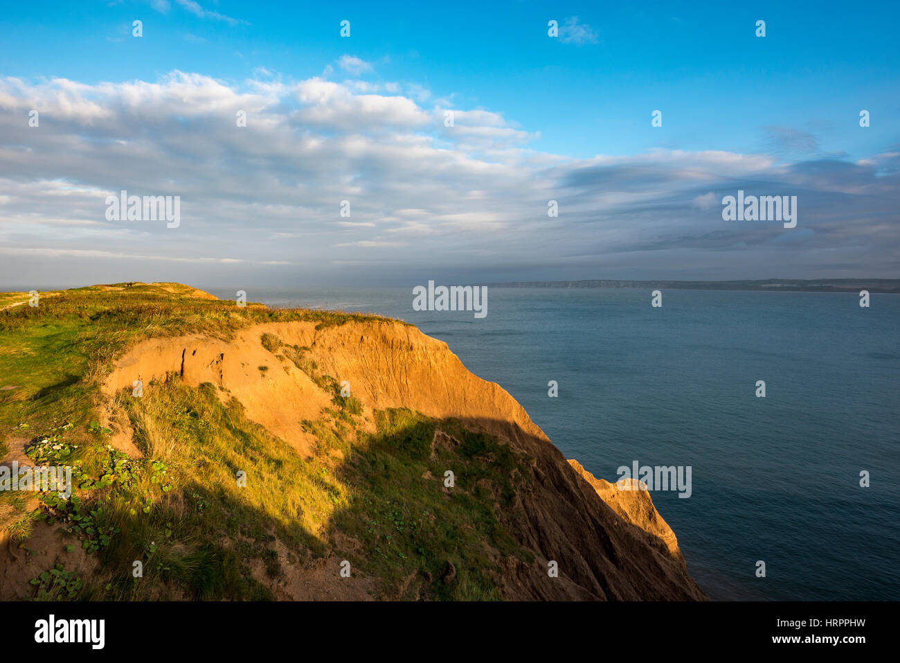 Evening sunlight on the cliffs at Filey Brigg at Filey on the coast of ...