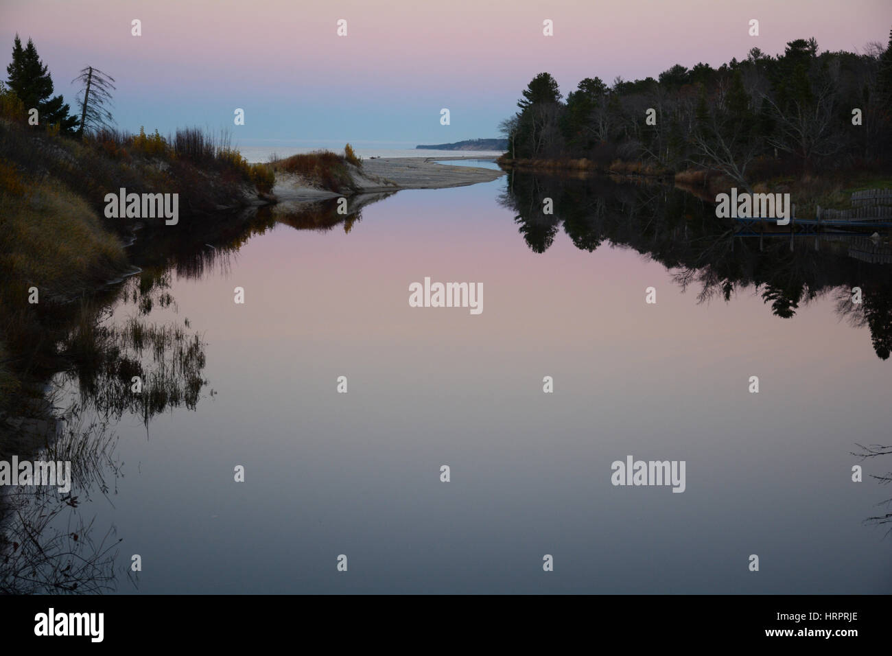 Looking down a very calm river after the sunset with the pink and blue ...