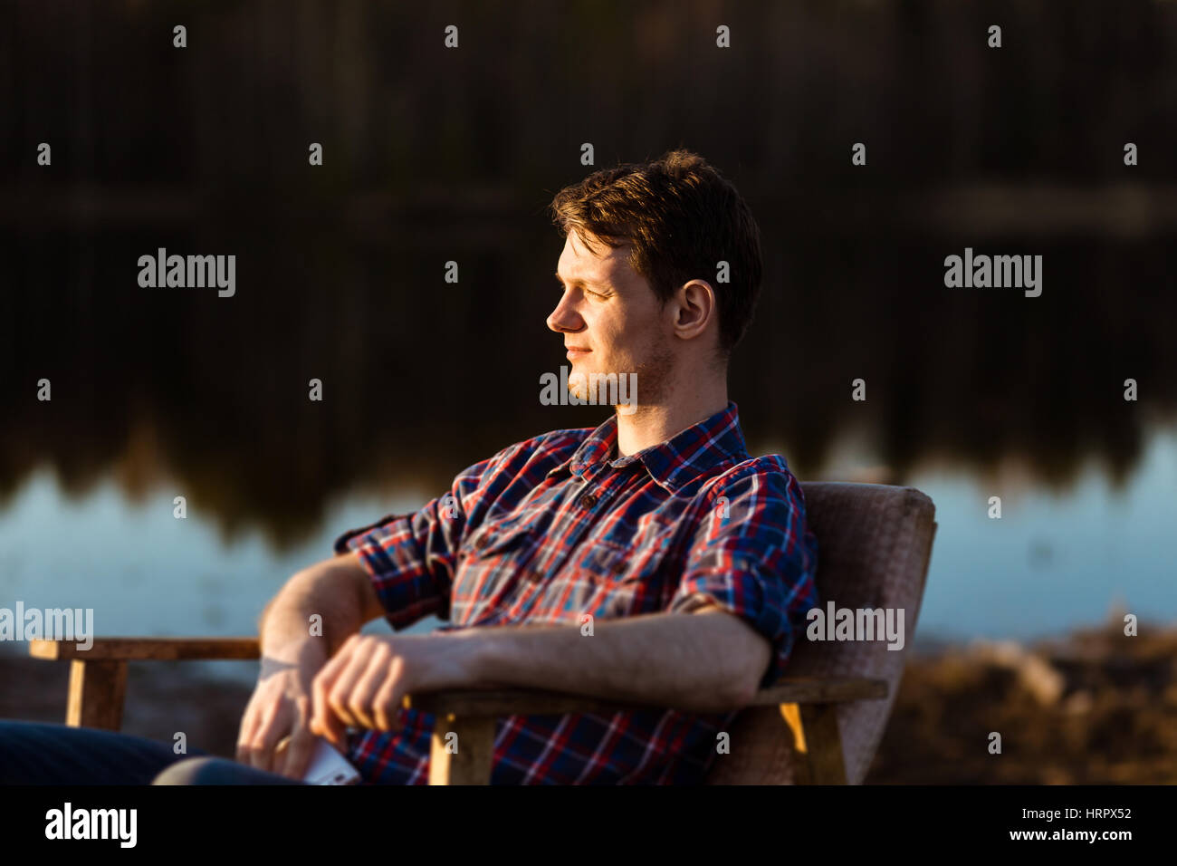 Man Looking afar by a Lake in Forest. Rest of Hipster Freelancer Stock ...