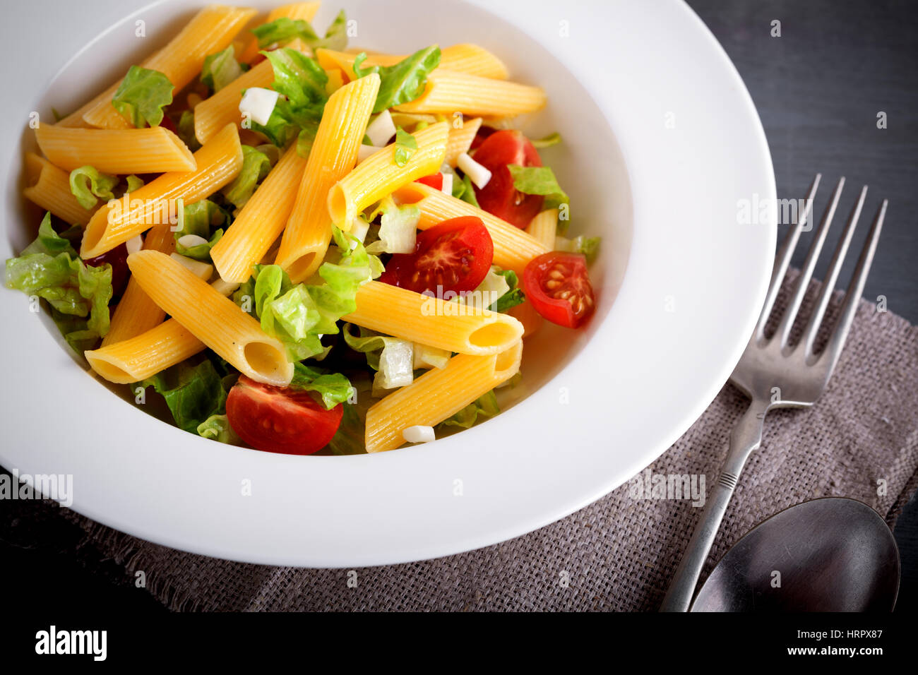 Pasta salad with fresh greenery and tomatos Stock Photo - Alamy