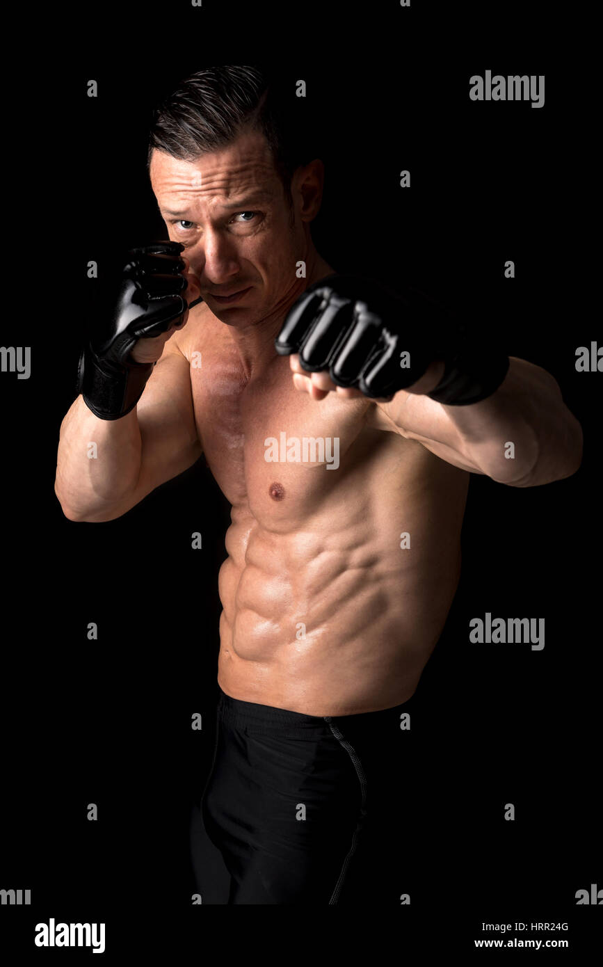 Strong Mixed Martial Arts fighter isolated in black Stock Photo - Alamy