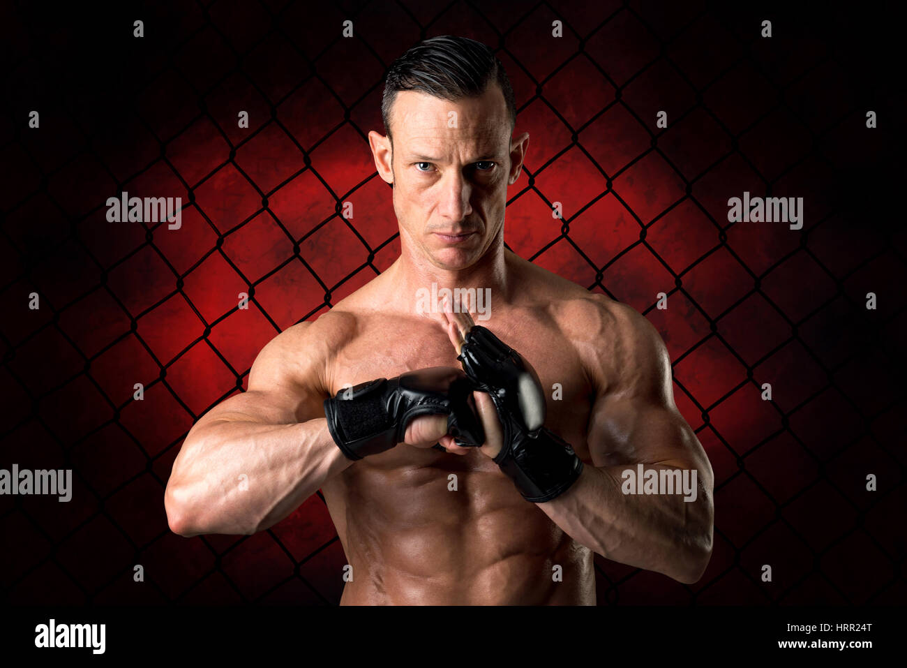 Strong Mixed Martial Arts fighter inside the cage Stock Photo - Alamy