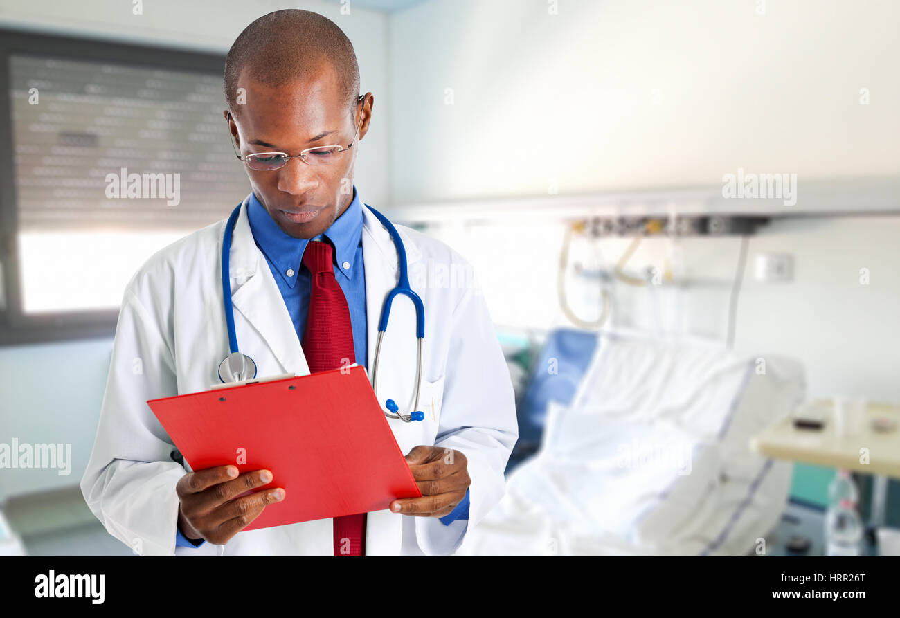 African doctor reading a clipboard Stock Photo - Alamy