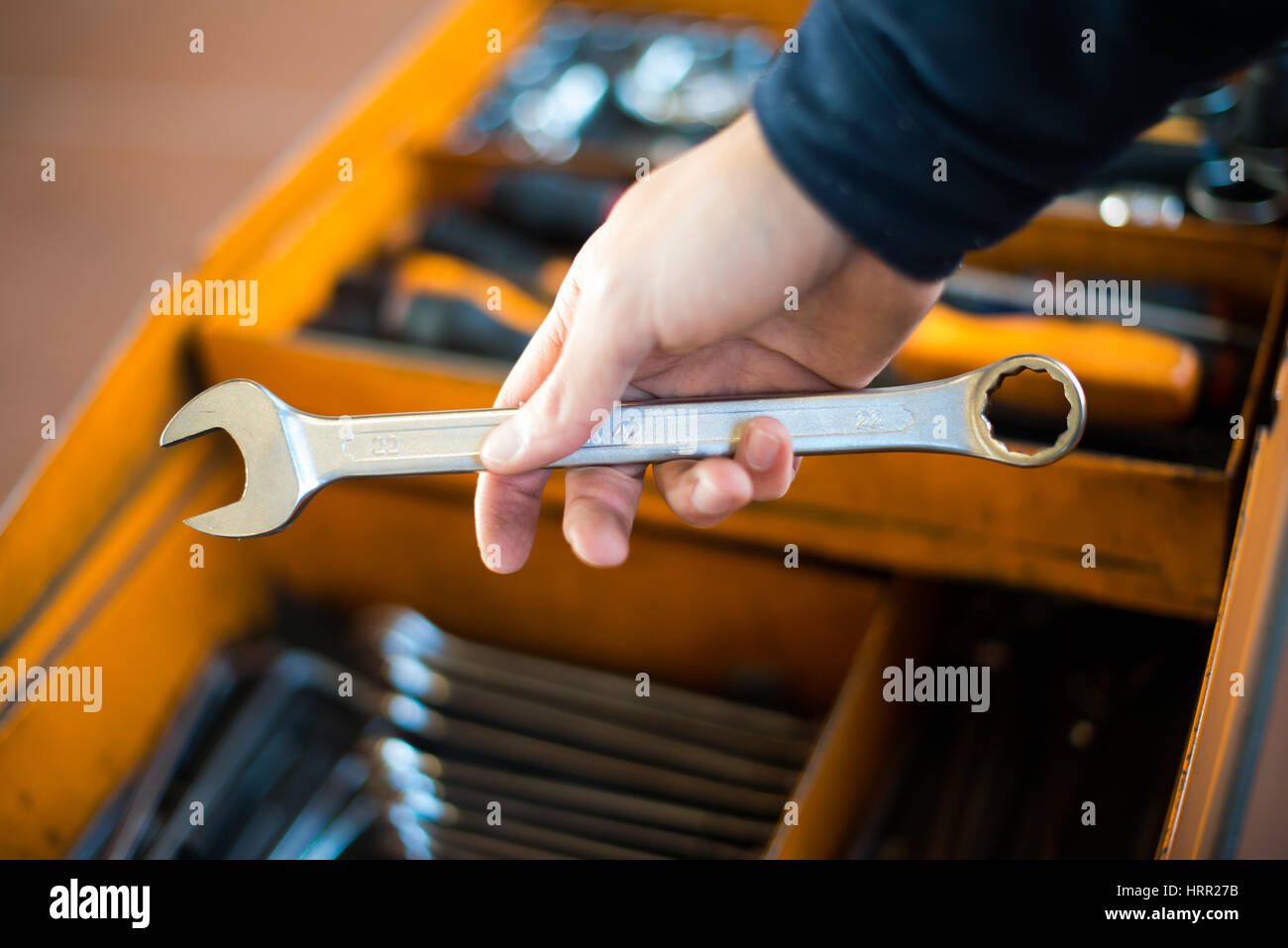 Mechanic's hand holding a wrench Stock Photo - Alamy