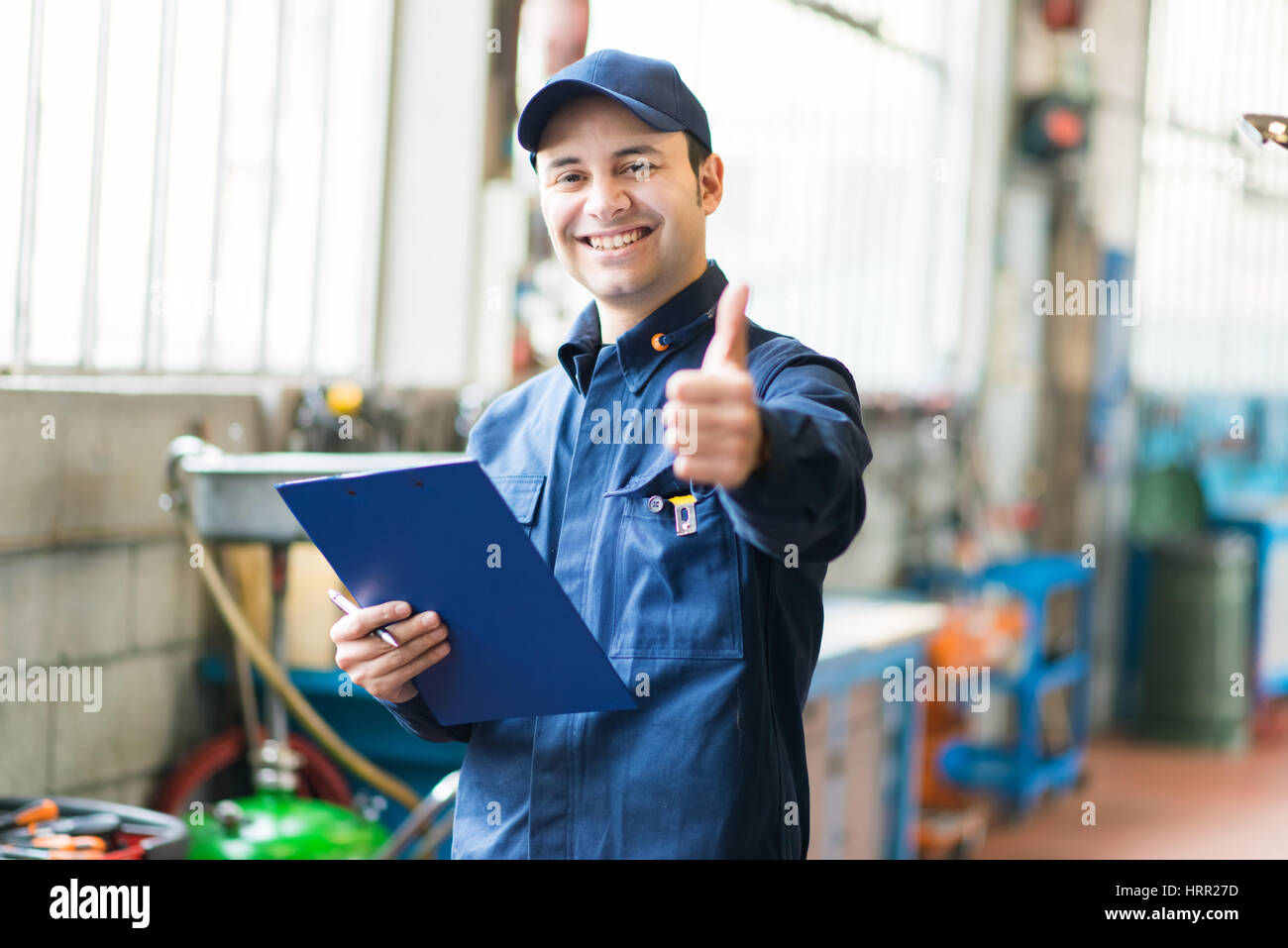 Smiling mechanic thumbs up Stock Photo - Alamy