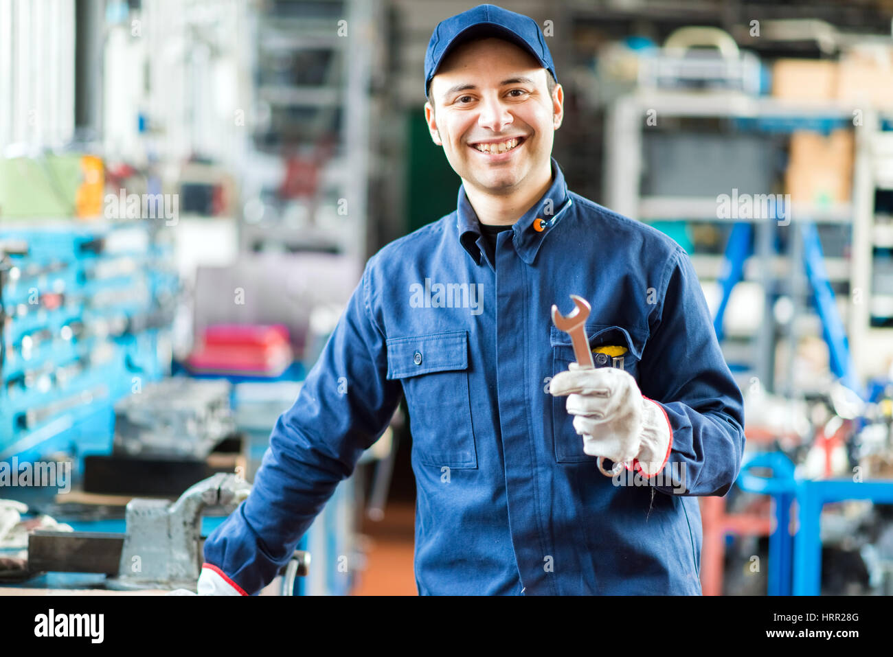 Auto mechanic smiling in his garage Stock Photo - Alamy