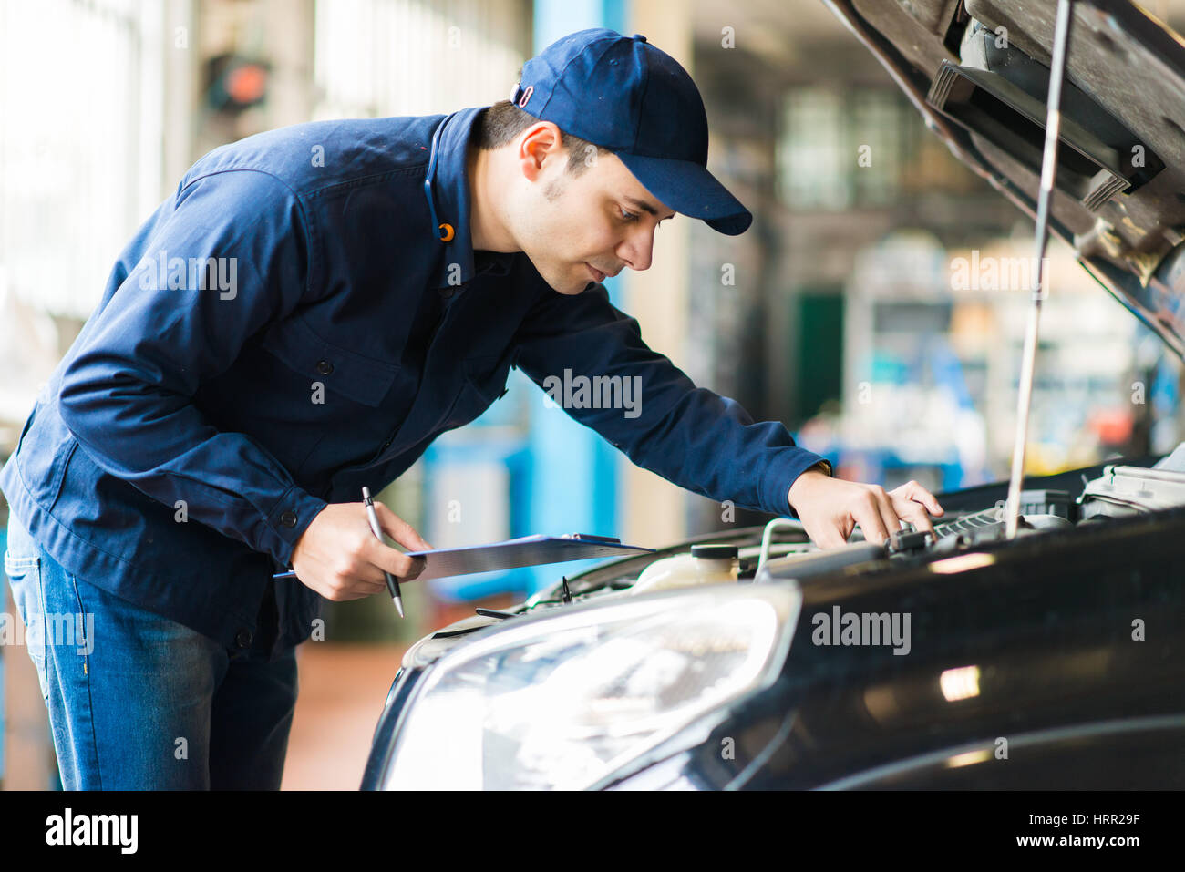 Mechanic at work in his garage Stock Photo - Alamy