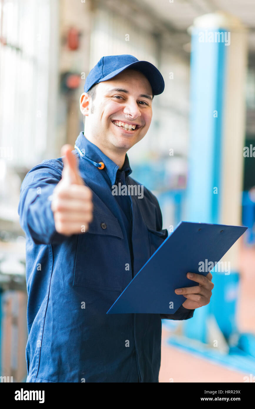 Smiling mechanic thumbs up Stock Photo - Alamy