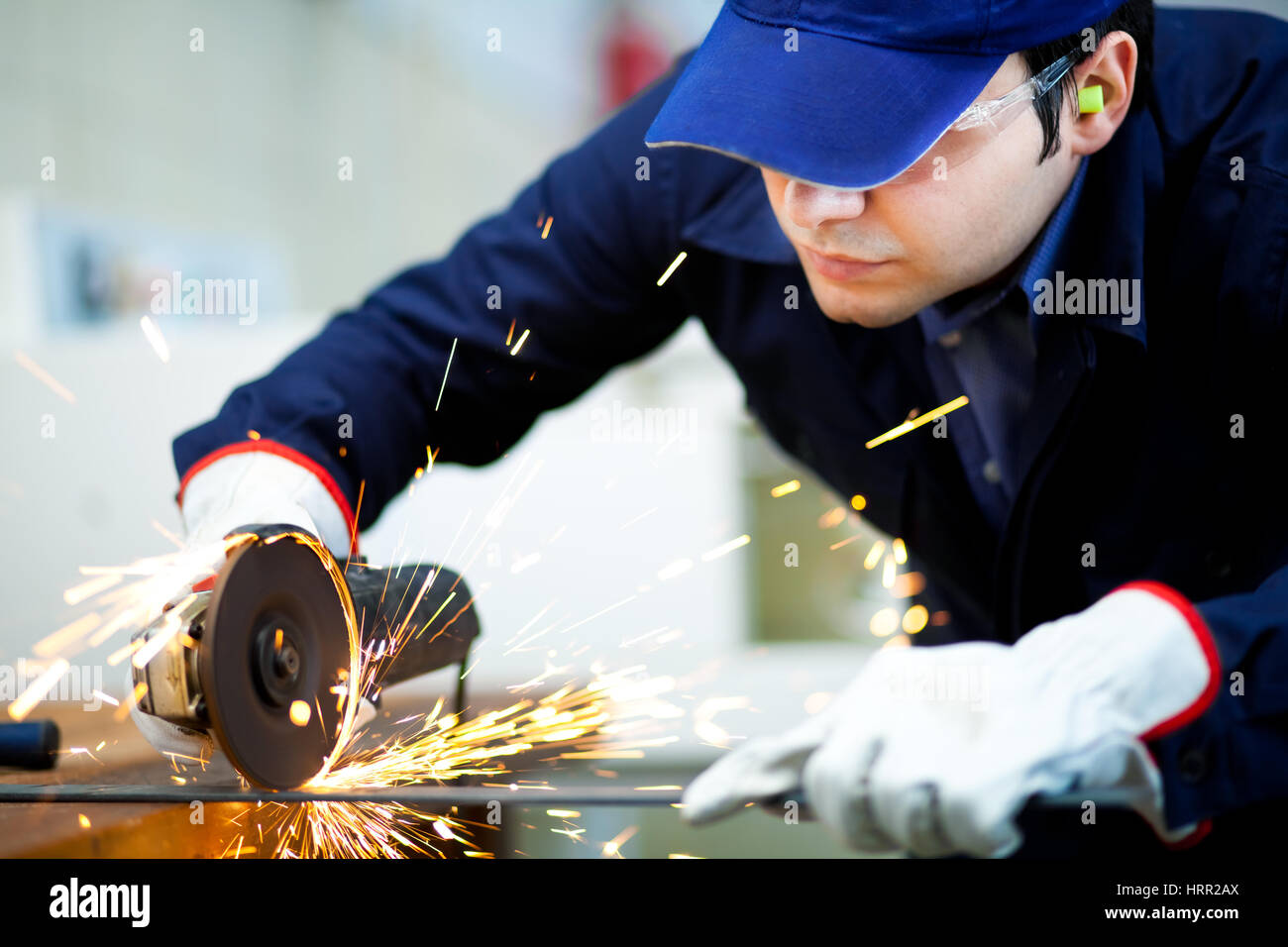 Worker grinding a metal plate Stock Photo - Alamy