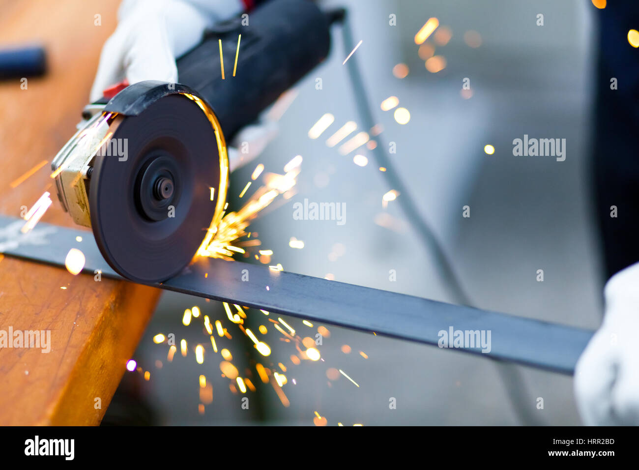 Worker grinding a metal plate Stock Photo - Alamy